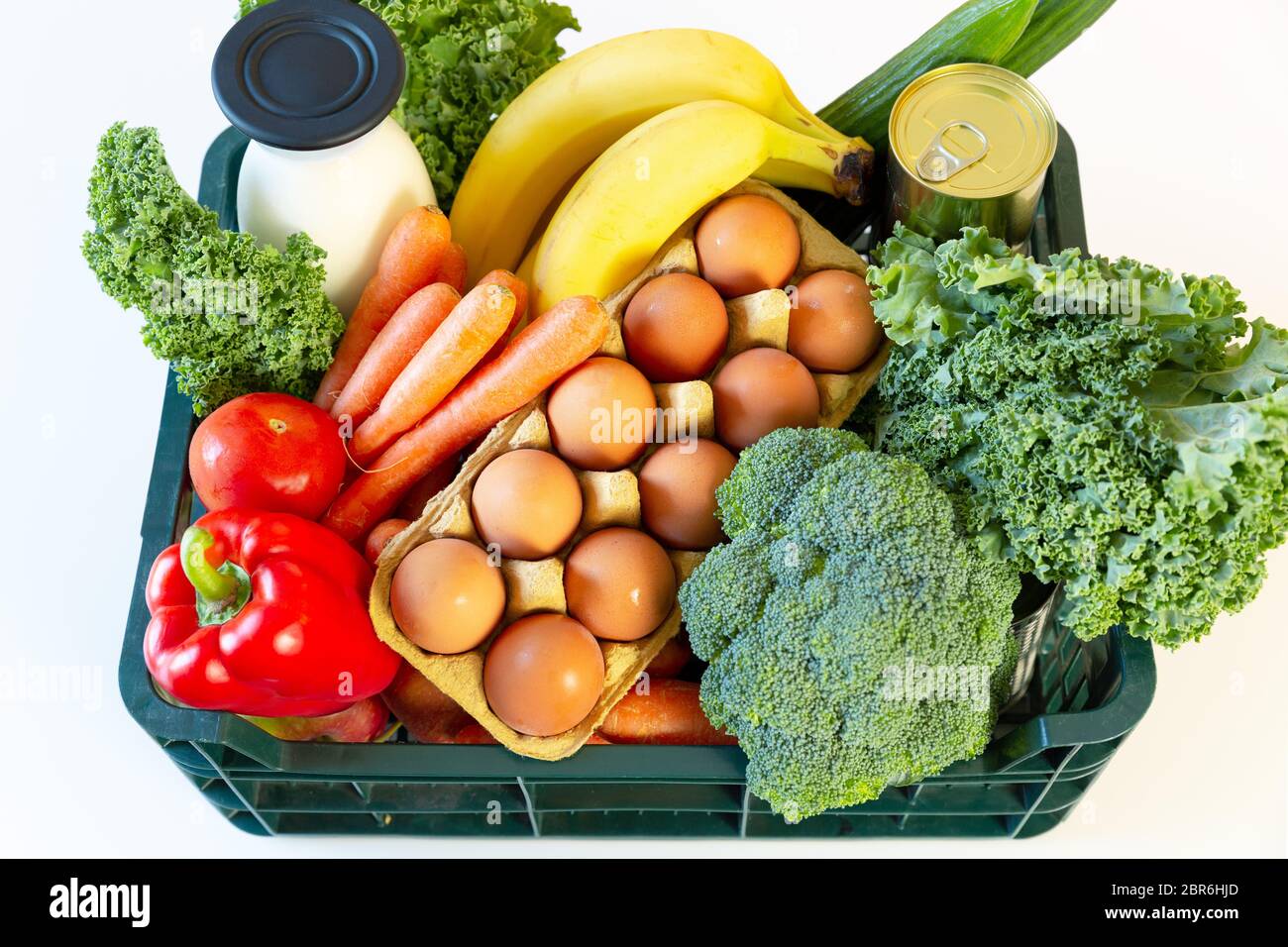 Fresh healthy groceries and vegetables from supermarket in green tray ...