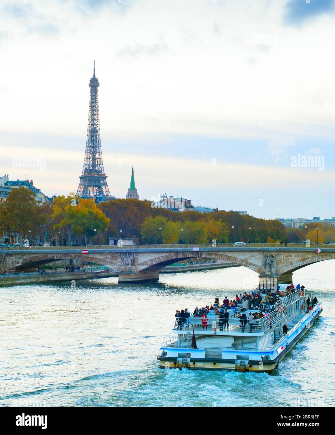Tourist boat at Sienna river, Paris skyline with Eiffel tower in ...