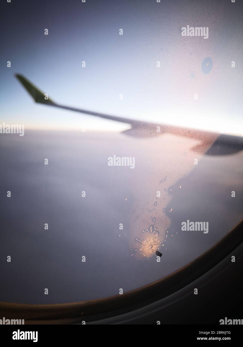 Color close up shot of a little hole in the window of a passenger ...