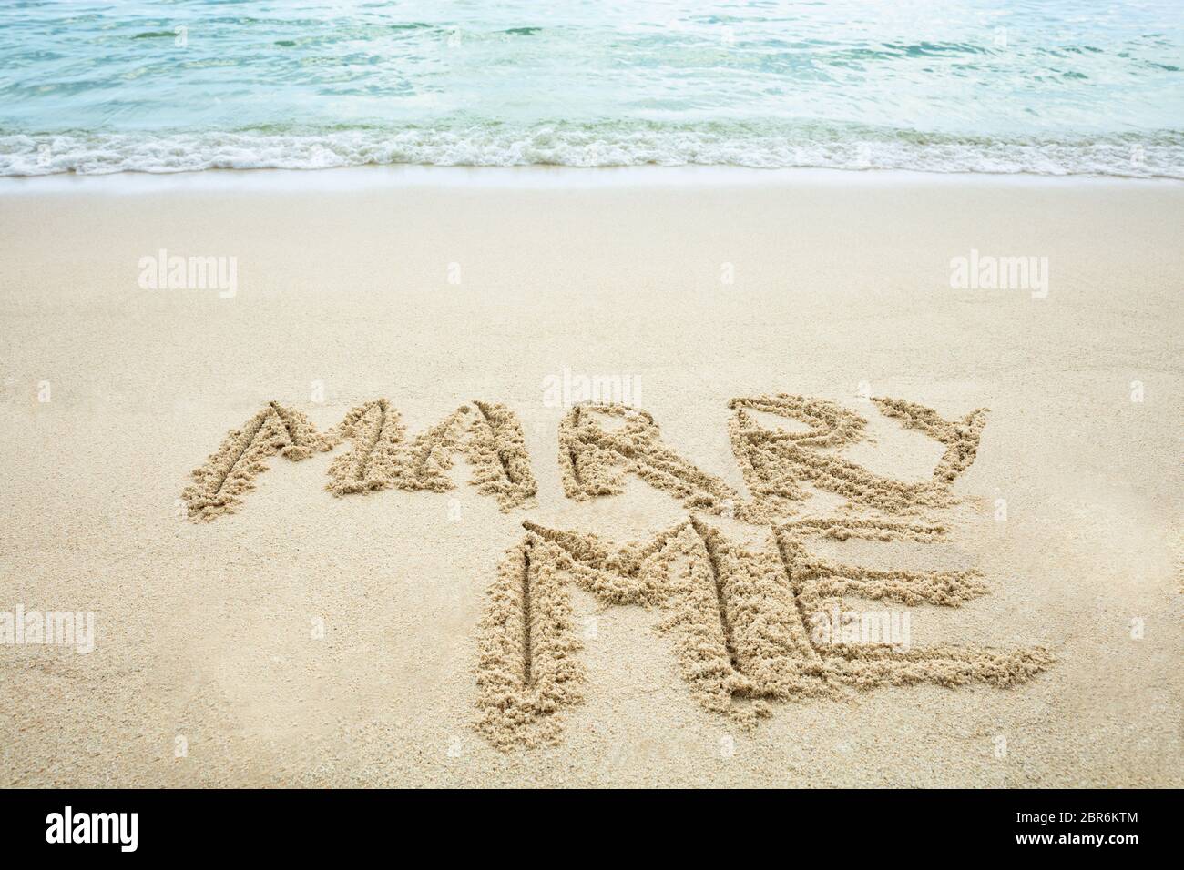 Marry Me Written On Sand With Footprints Near The Sea At Beach Stock ...