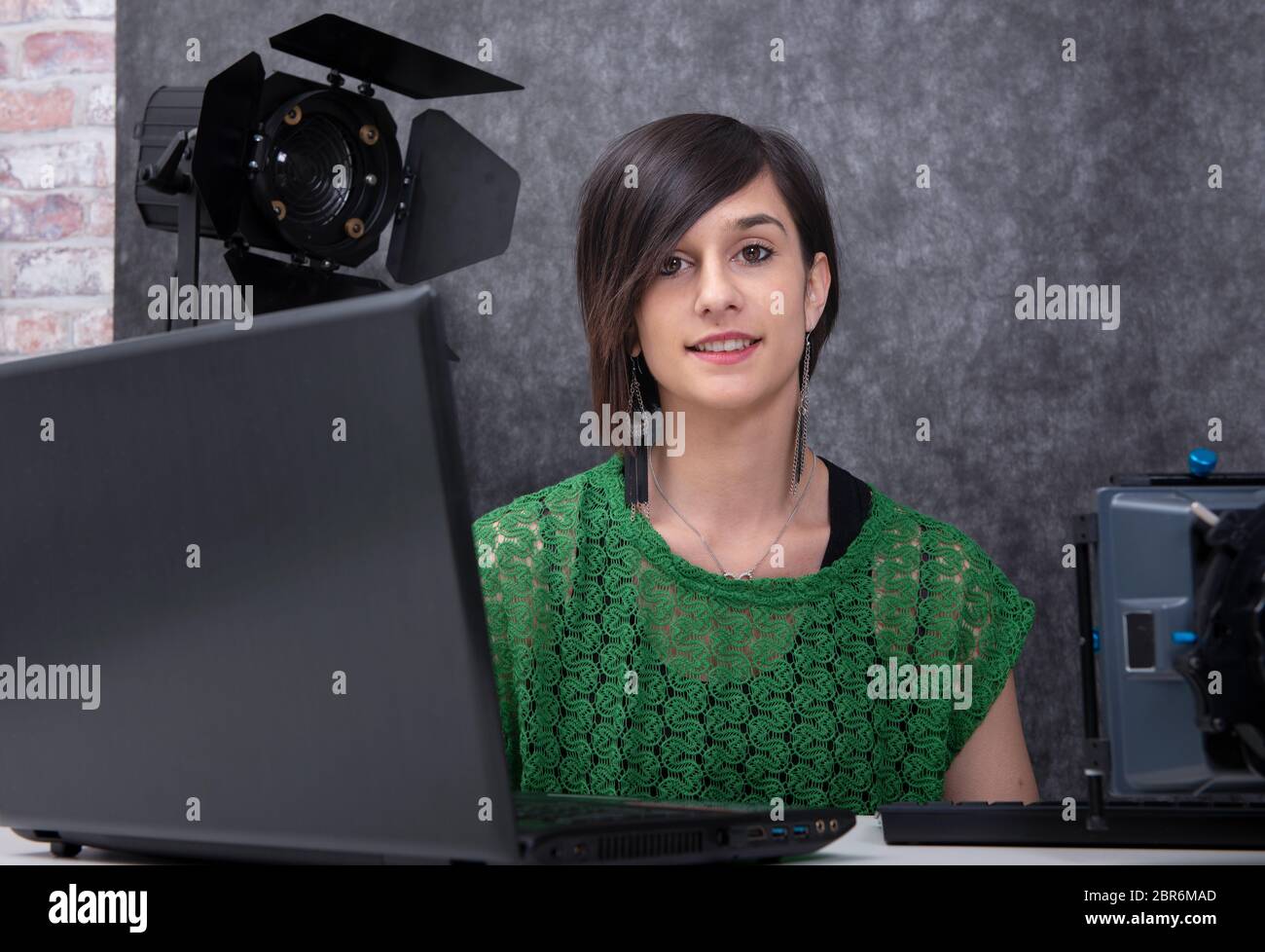 pretty young woman video editor working in studio Stock Photo - Alamy