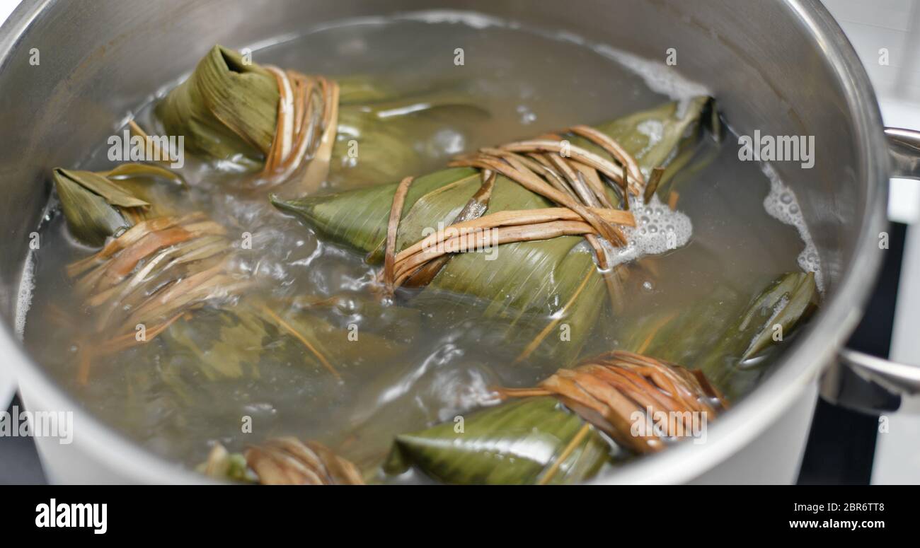 Cook with bamboo sticky rice dumpling Stock Photo - Alamy