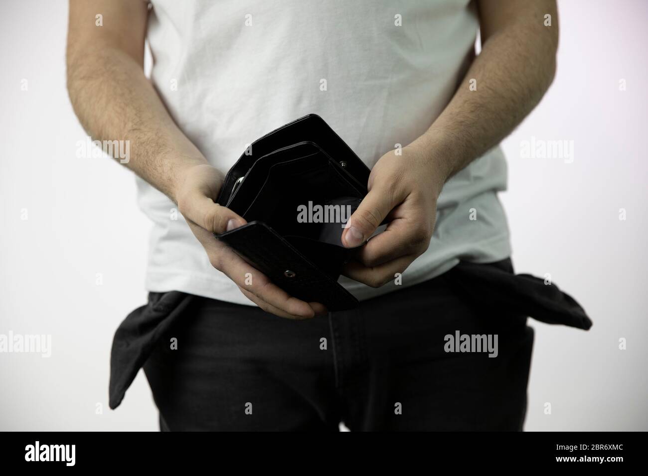 Young man in jeans with empty pockets shows his empty wallet Stock ...