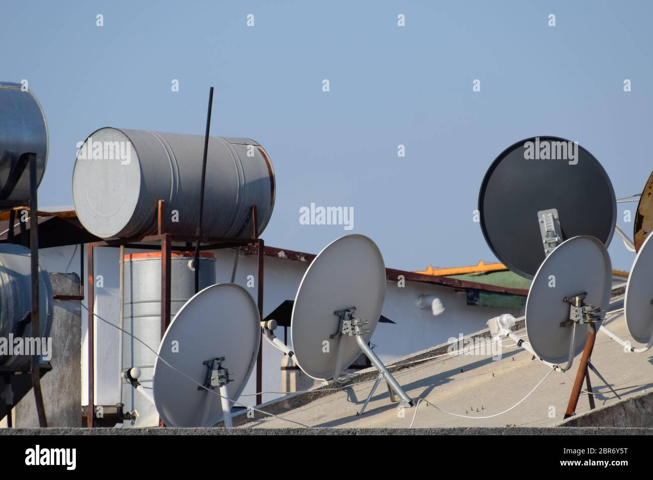 Steel barrels of boilers with water on the roof of a building to heat ...