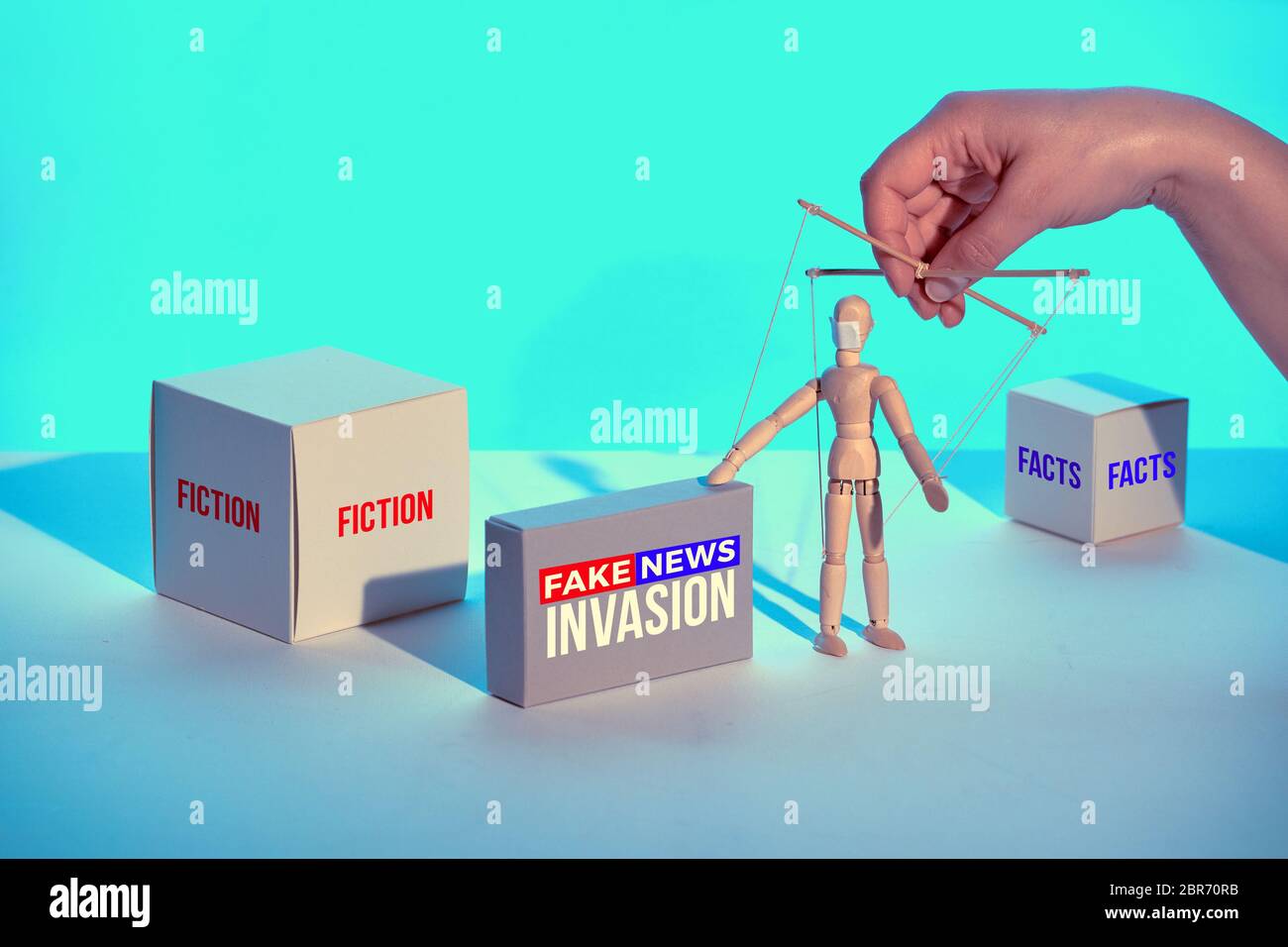 Box with text " fake news invastion". Sinister hand controls ...