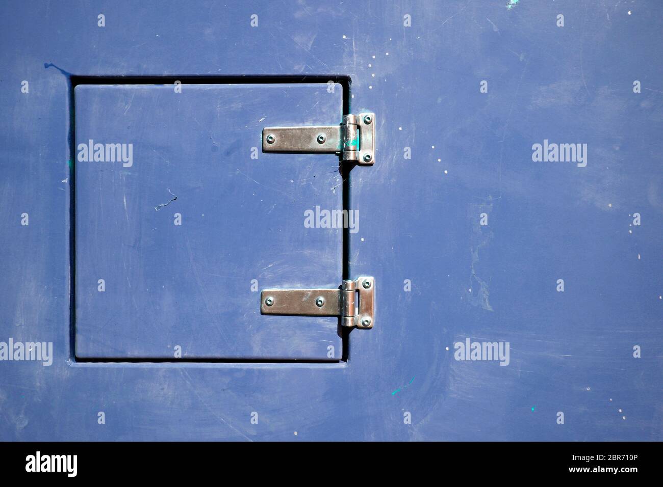 Blue metal container with closed hinged door Stock Photo - Alamy