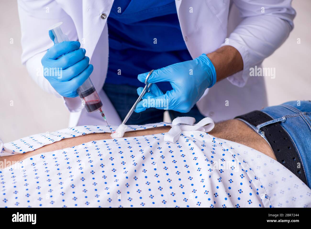 Old man visiting young intern doctor Stock Photo - Alamy