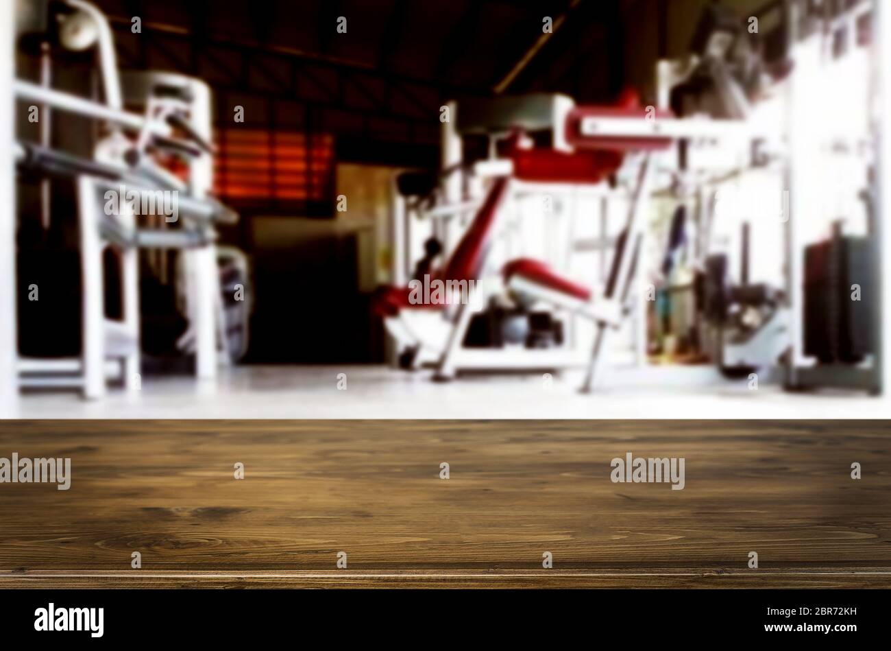 Wooden table on blurred background of fitness gym interior of modern ...