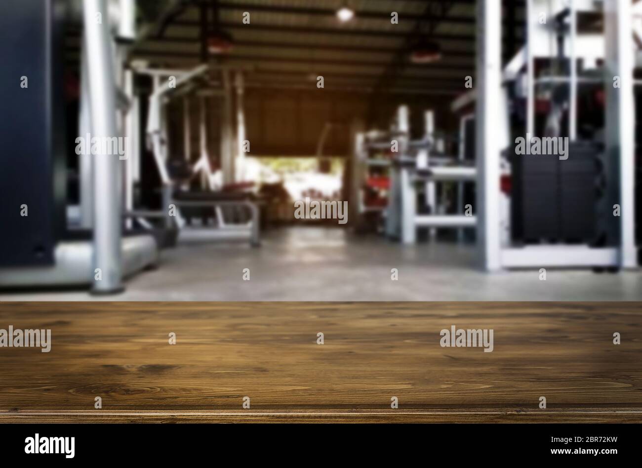 Wooden table on blurred background of fitness gym interior of modern ...