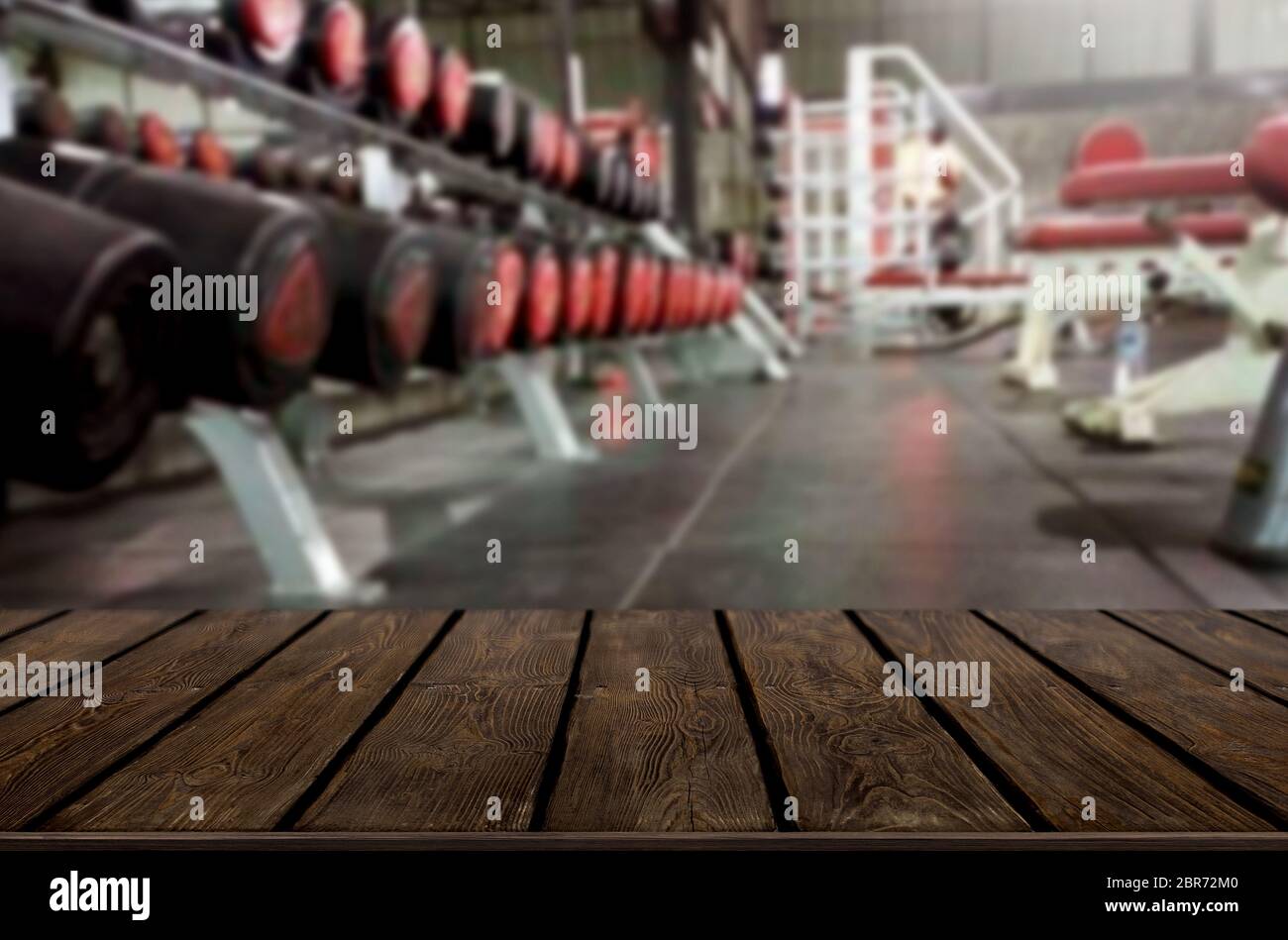 Wooden table on blurred background of fitness gym interior of modern ...