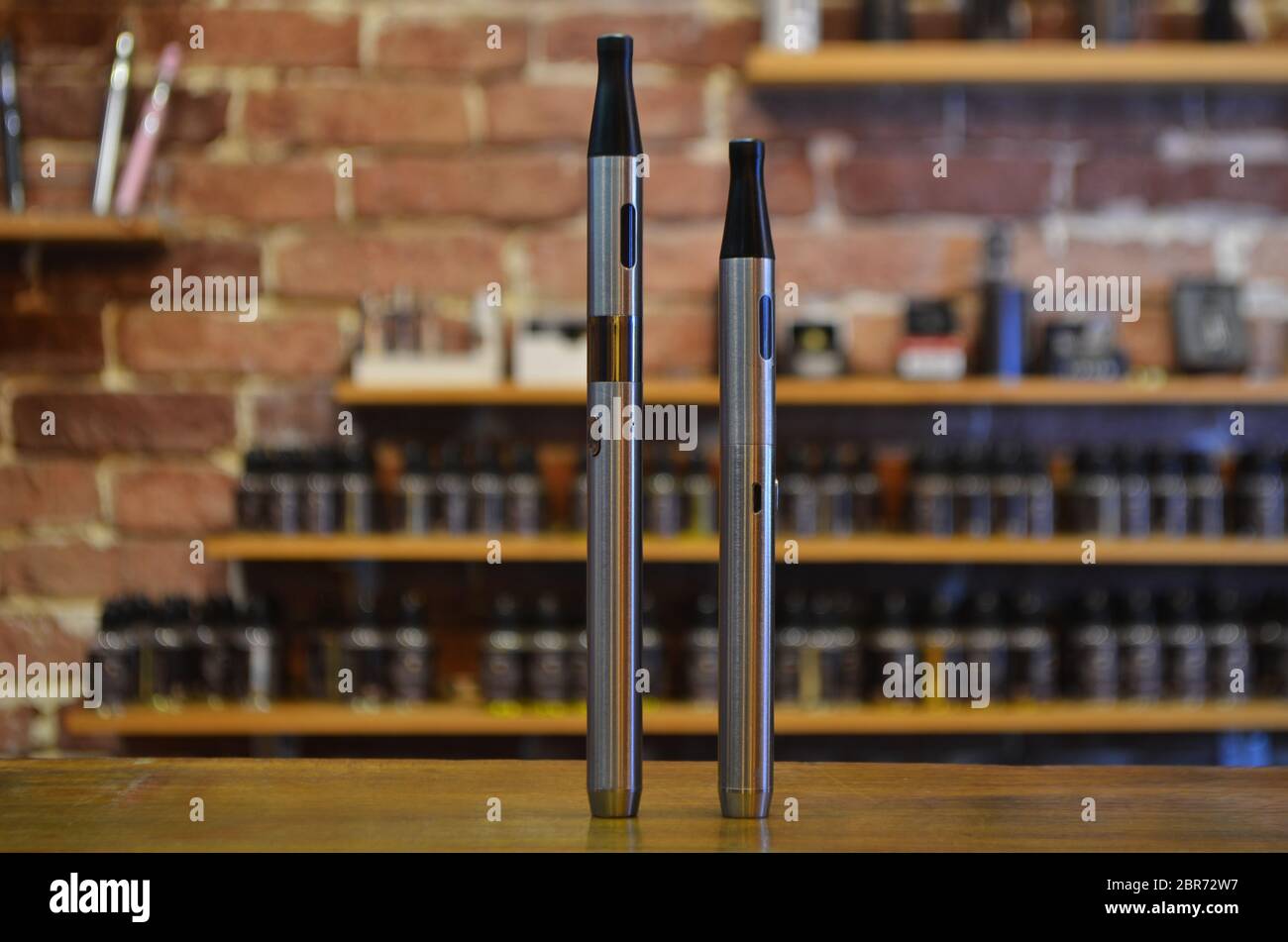 Electronic cigarette on a background of vape shop. E-cigarette for ...
