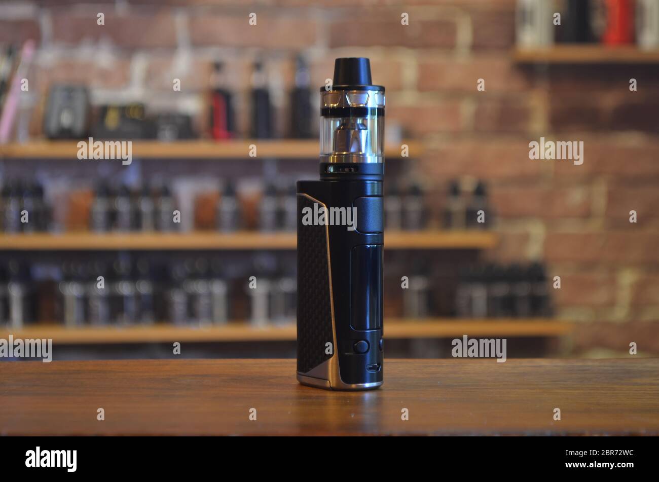 Electronic cigarette on a background of vape shop. E-cigarette for ...