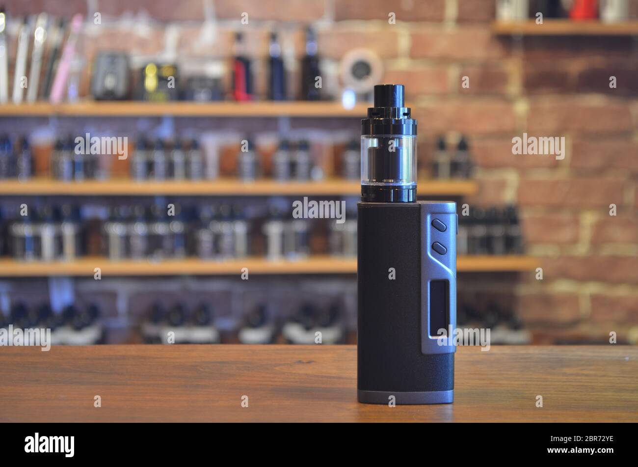 Electronic cigarette on a background of vape shop. E-cigarette for ...