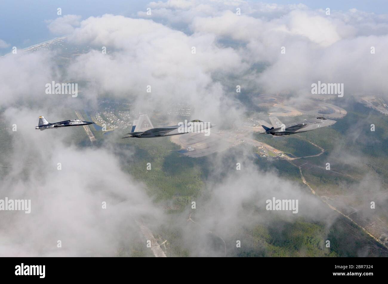 A T-38 Talon and a F-22 Raptor from the 325th Fighter Wing fly ...