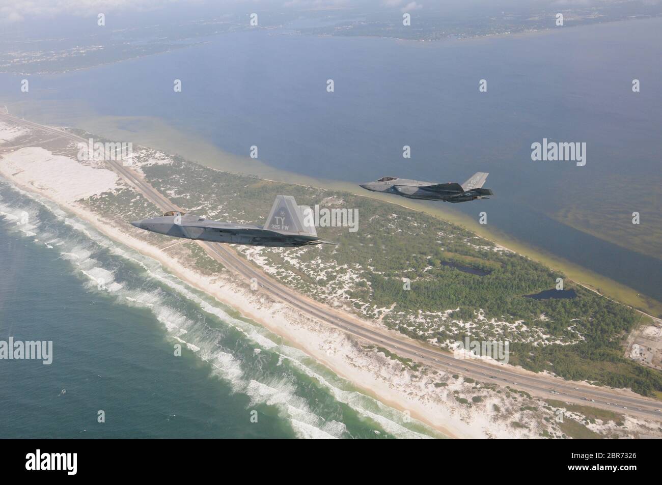 A F-22 Raptor from the 325th Fighter Wing flies alongside a F-35 ...