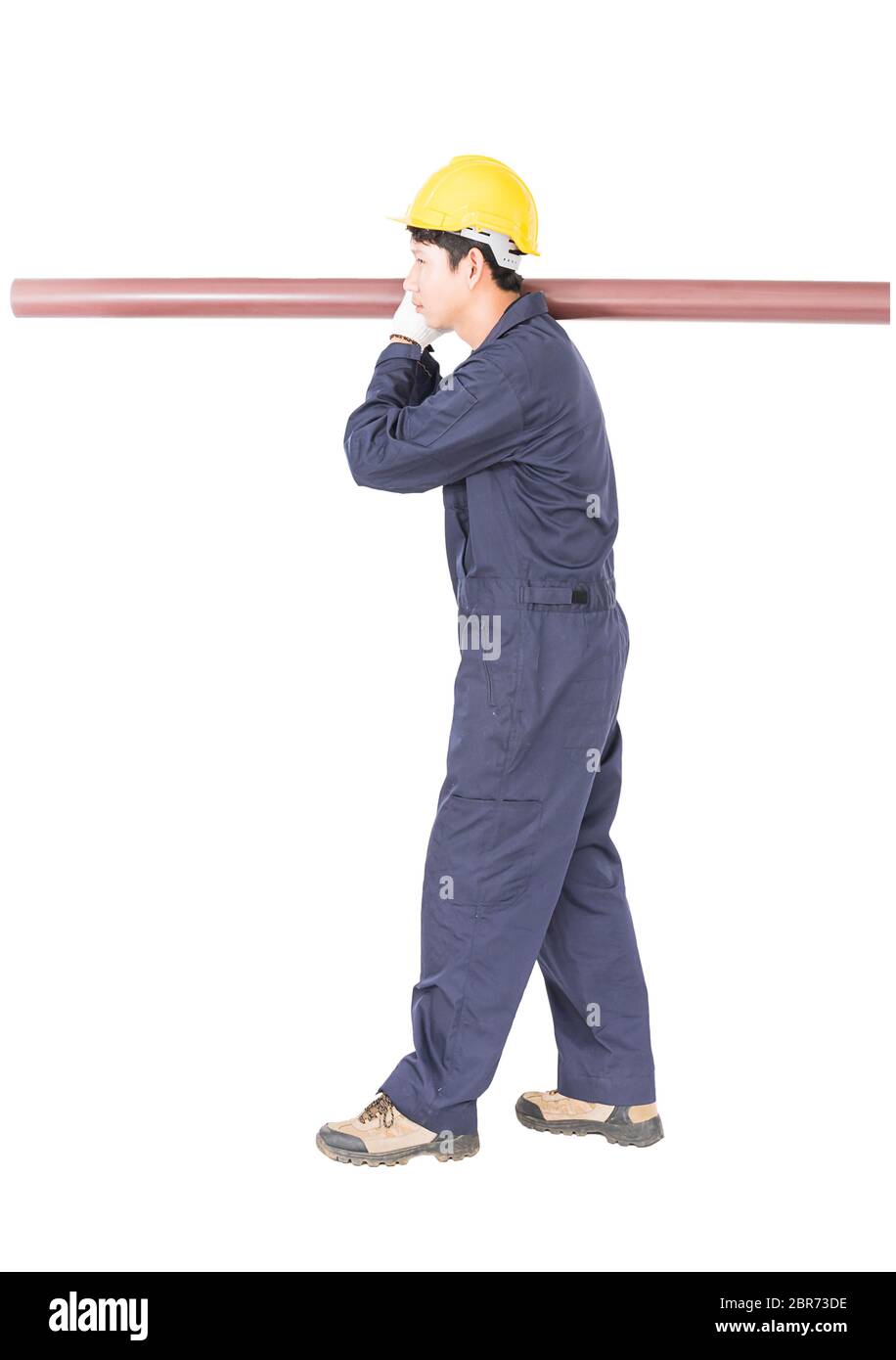 Young plumber in unifrom holding pvc pipe isolated on white background ...