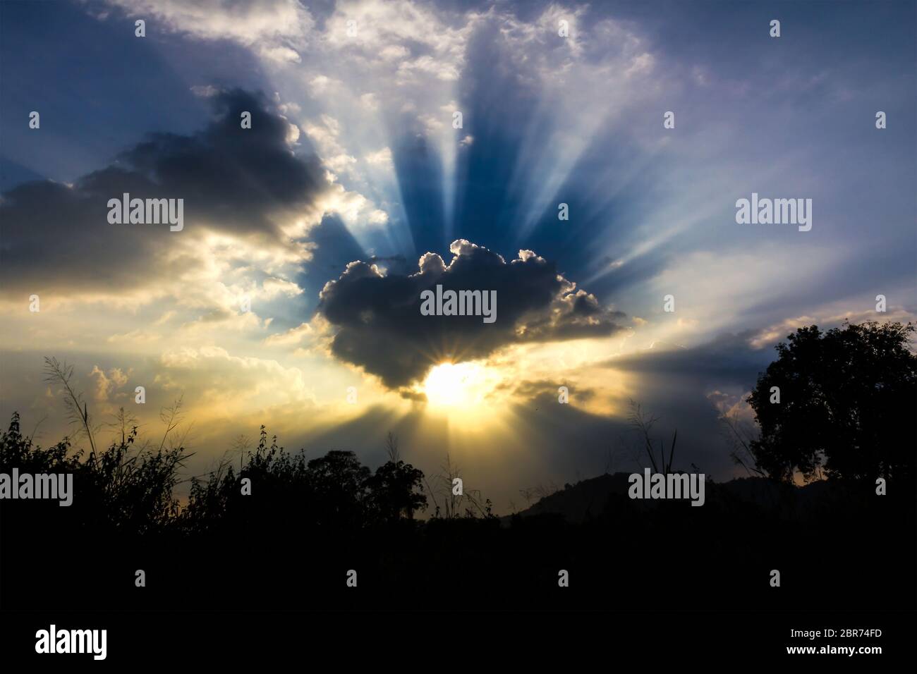 Image of sun shine through rain cloud Stock Photo - Alamy