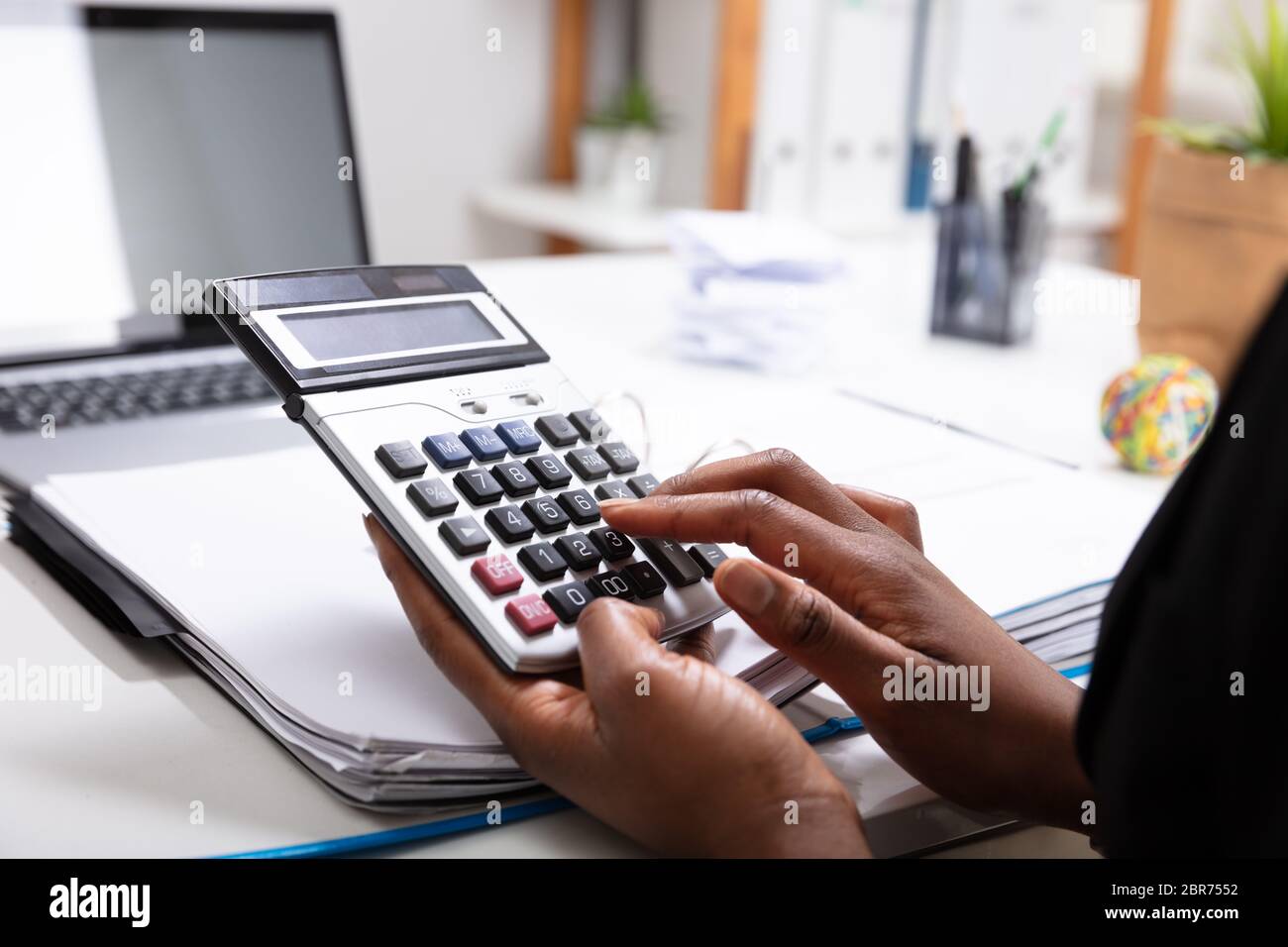Photo Of Businesswoman's Hand Calculating Bill In Office Stock Photo ...