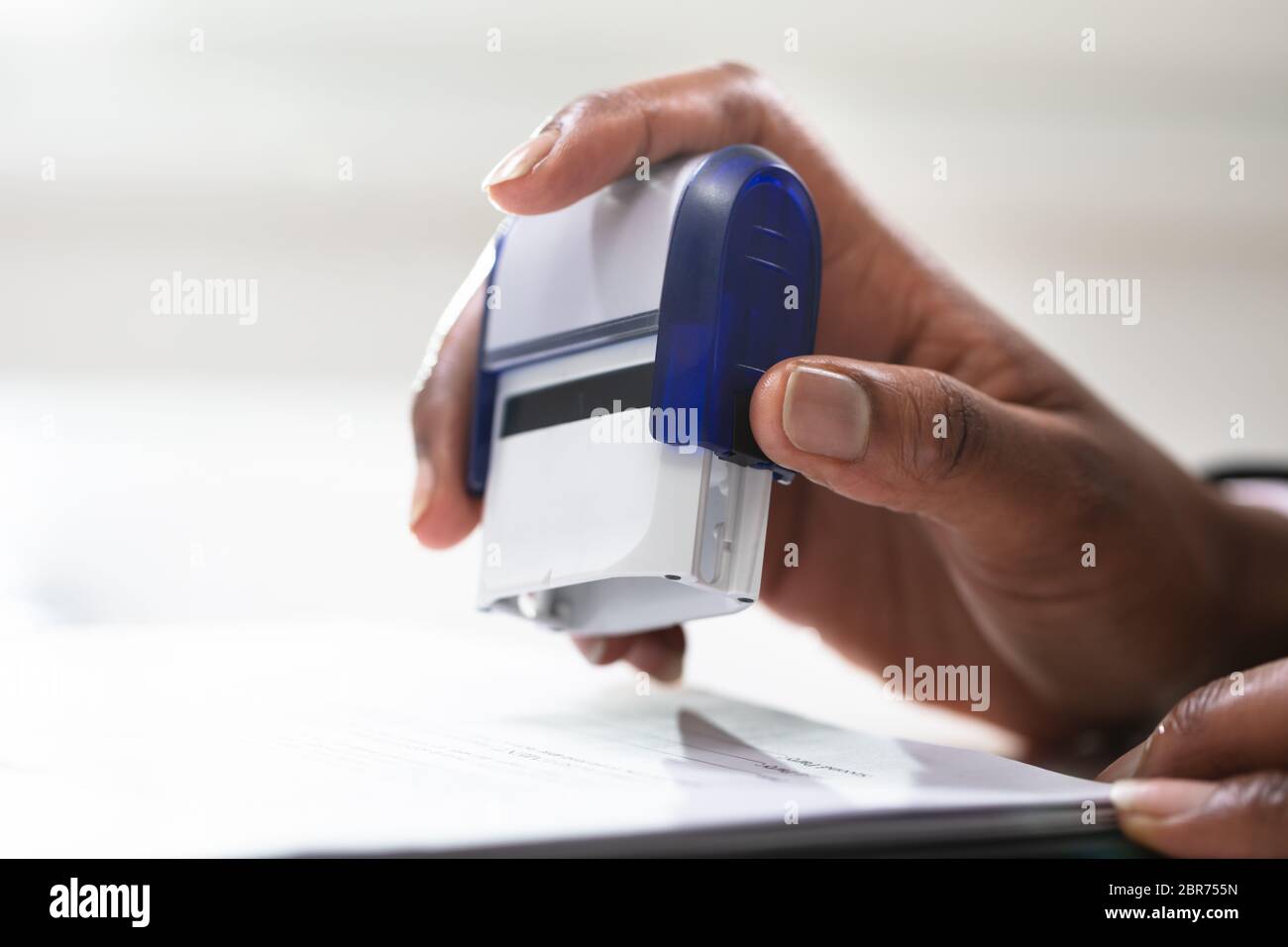Close-up Of Businesswoman Putting Stamp On Documents In The Office ...