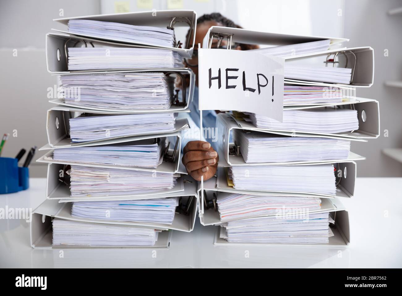 Businesswoman Holding White Help Flag With Stack Of Folders Stock Photo ...