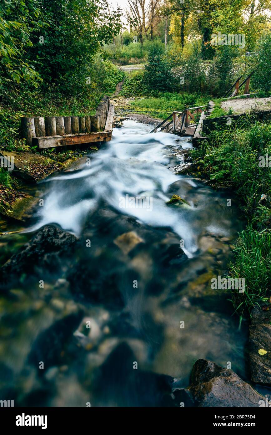 Small forest river flowing through rocks and boulders Stock Photo - Alamy
