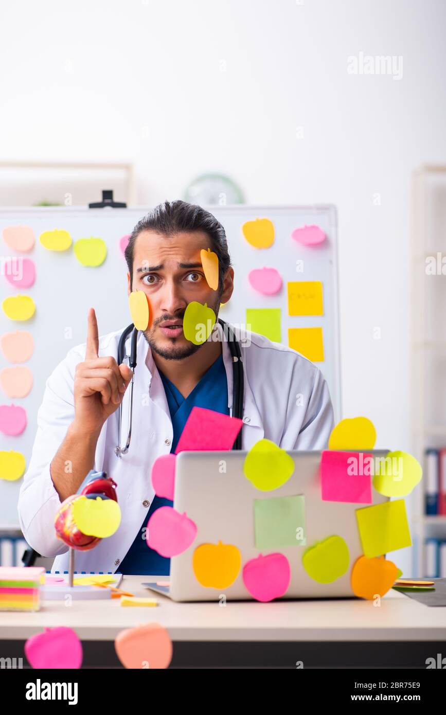 Young medic in conflicting priorities concept Stock Photo - Alamy