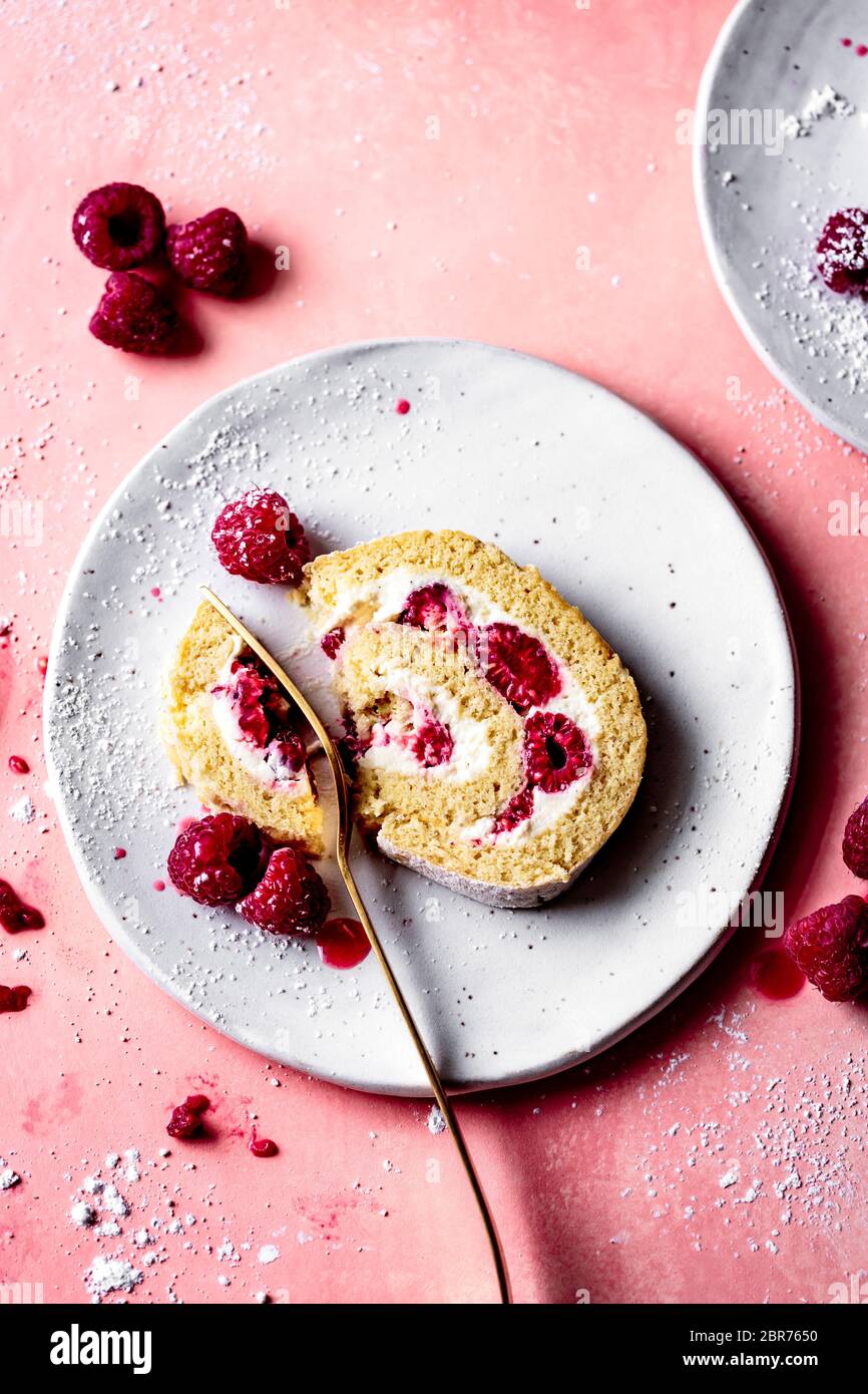 Slice of raspberry roll cake with fresh cream Stock Photo - Alamy