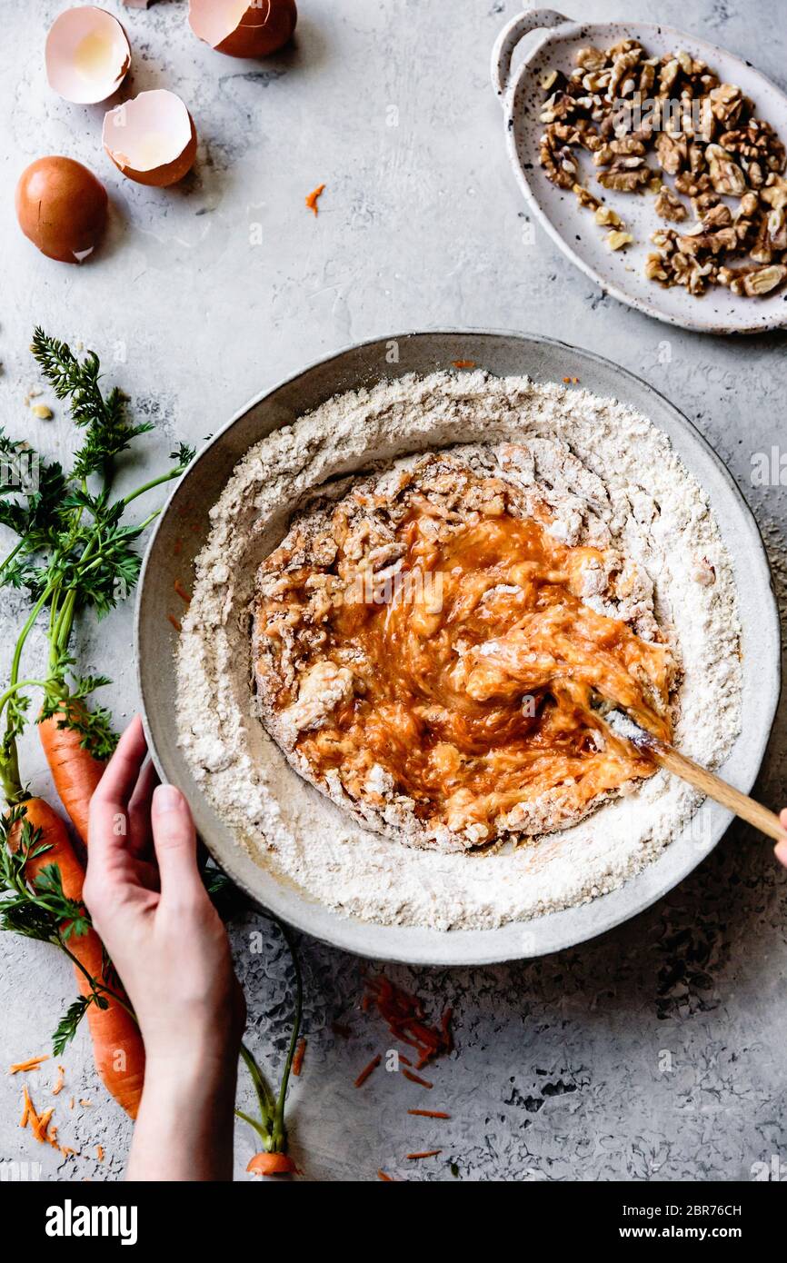 Stirring cake batter with a hand held spoon Stock Photo - Alamy