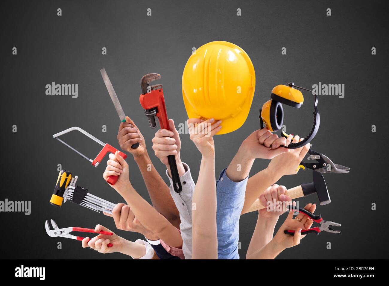 Close-up Of People's Hand Holding Carpentry Tools Against Black ...