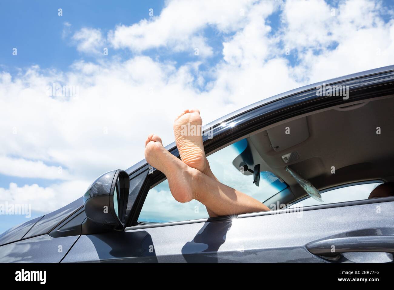 Close-up Of Crossed Woman's Leg Out Of Car Window At Beach Stock Photo ...