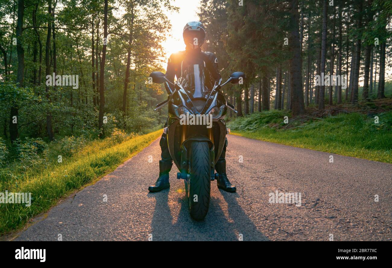 motorbike on the forest road riding. having fun driving the empty road ...
