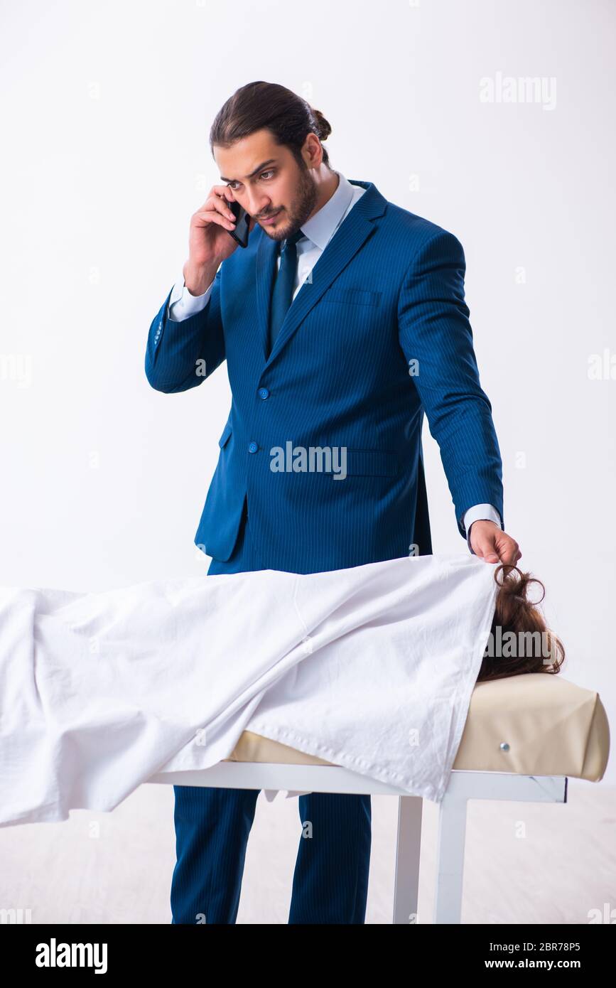 Police coroner examining dead body in morgue Stock Photo - Alamy