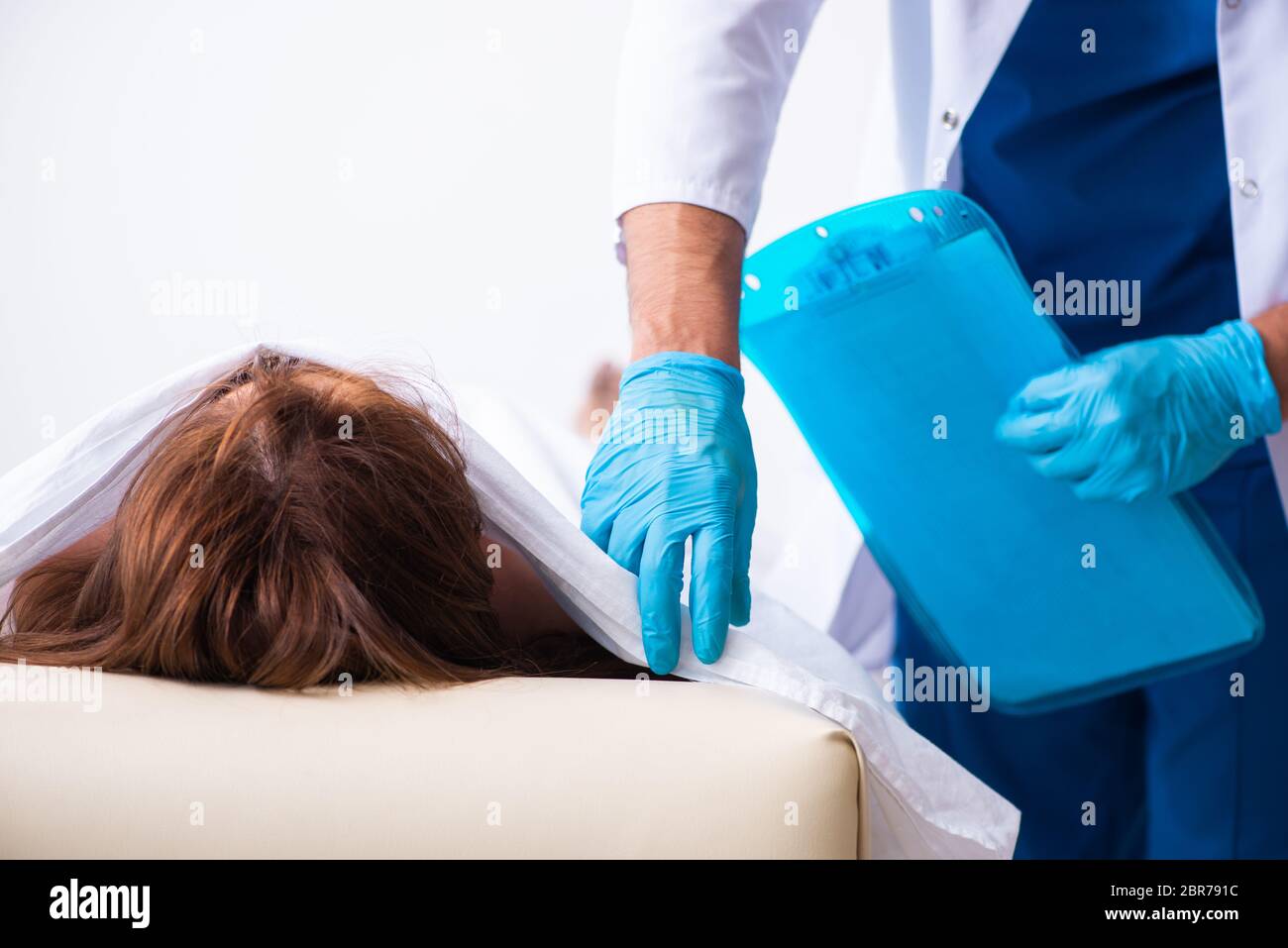 Police coroner examining dead body in morgue Stock Photo - Alamy