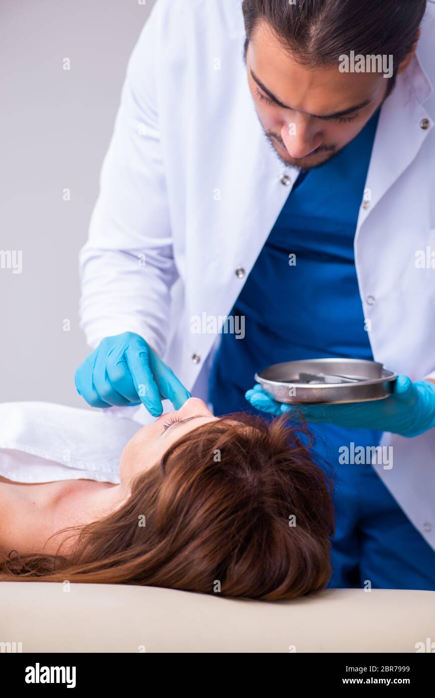 Police coroner examining dead body in morgue Stock Photo - Alamy
