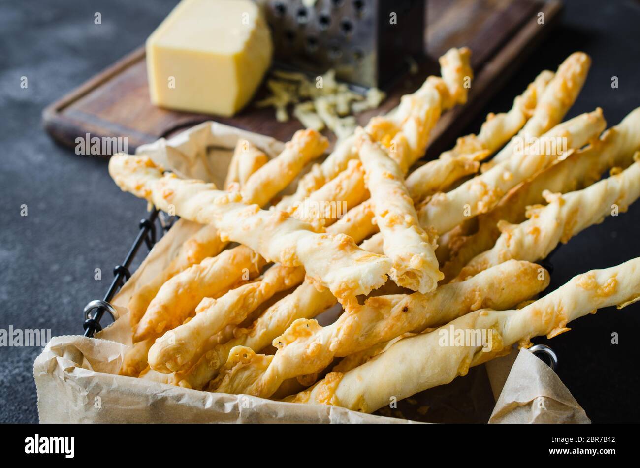 Cheese stick. Breadsticks with cheese on dark background, concept for ...
