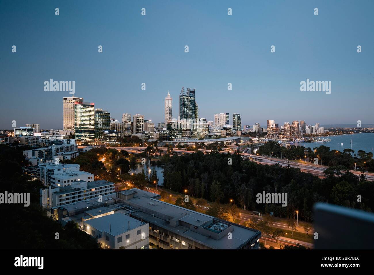 Wide shot of Perth's skyline at night with Swan River and natural ...