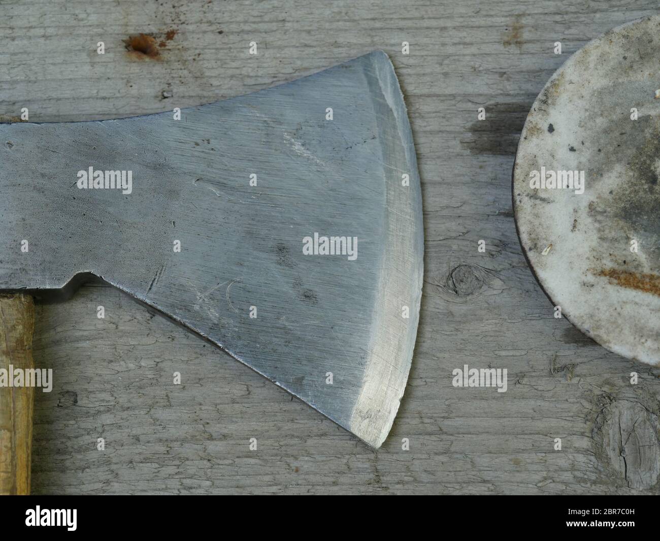 sharp ax blade and round sharpened Stock Photo - Alamy