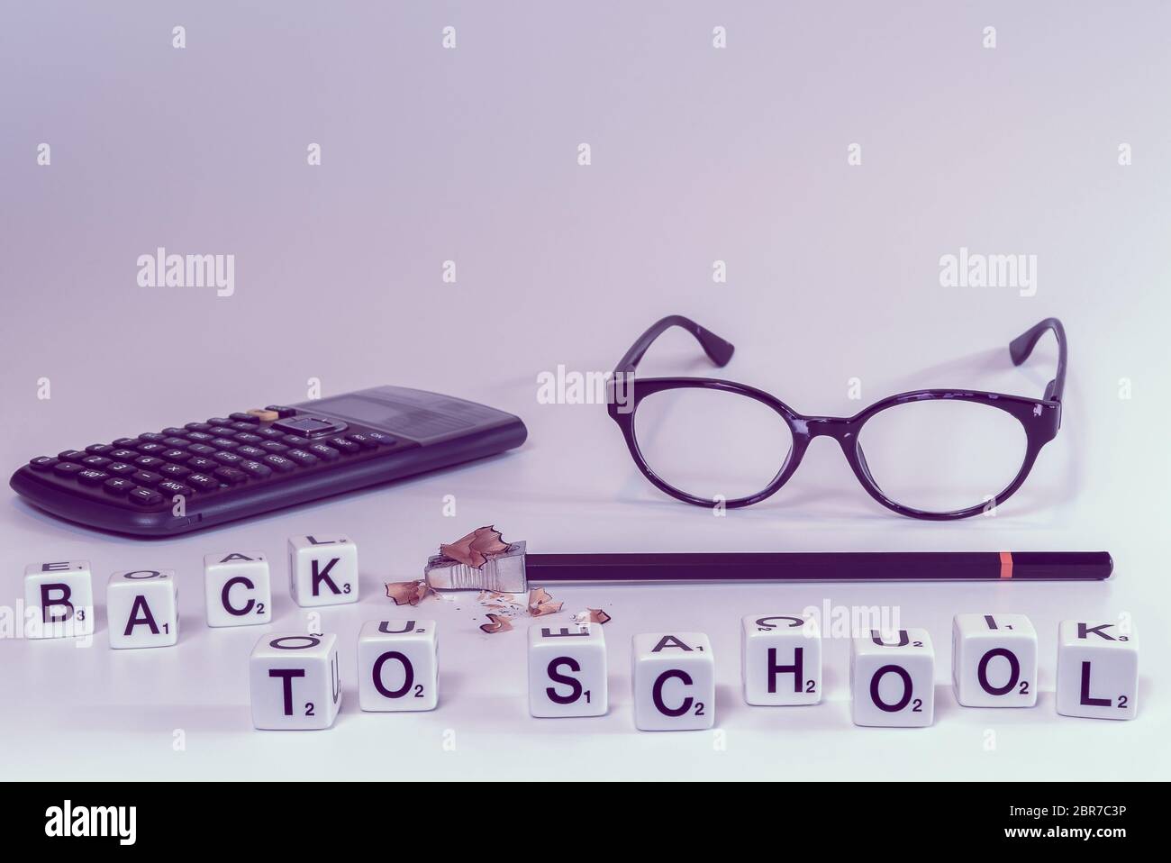 Front view of school supplies with scrabble letters spelling the words ...