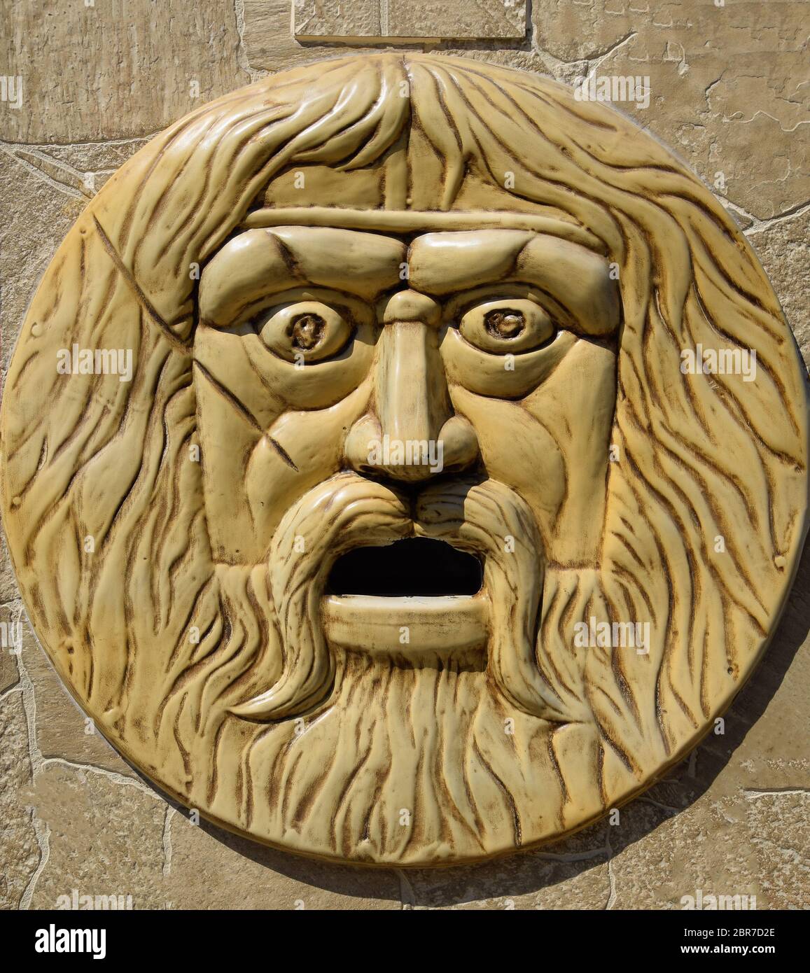 bas-relief, the face of a bearded and hairy man Stock Photo - Alamy