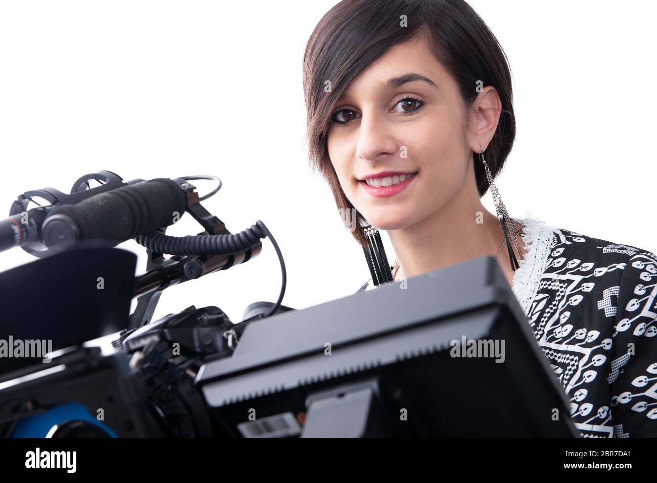 young woman with professional video camera, DSLR, isolated on white ...
