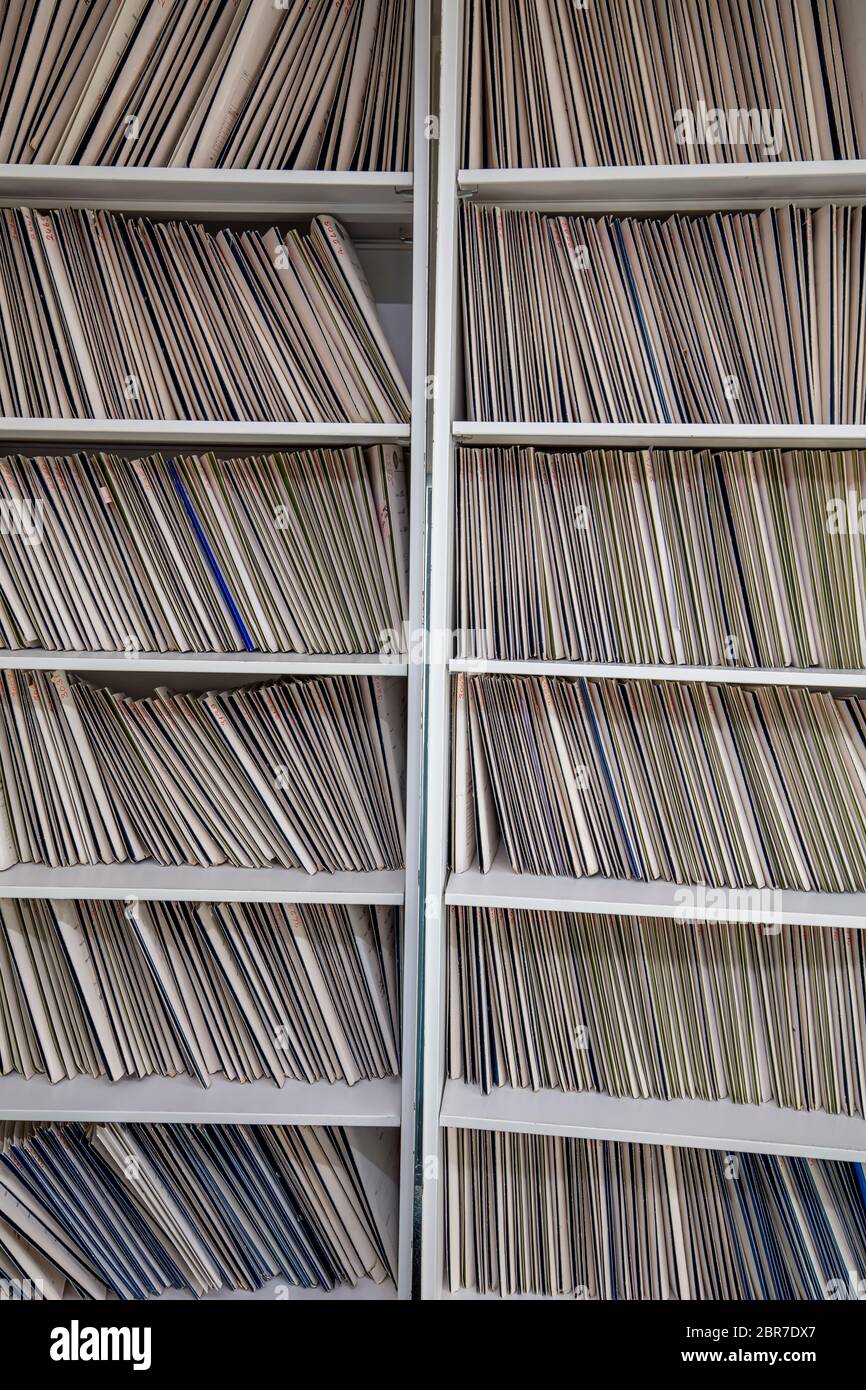 A shelf full of manila folders containing files and information in an ...