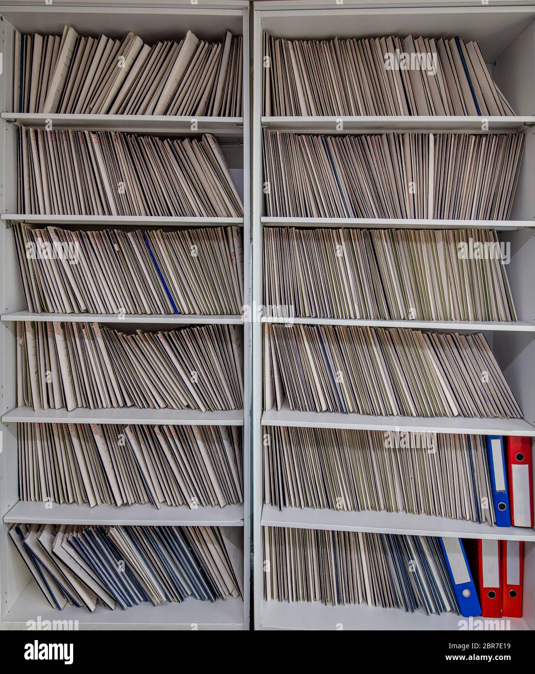 A shelf full of manila folders containing files and information in an ...