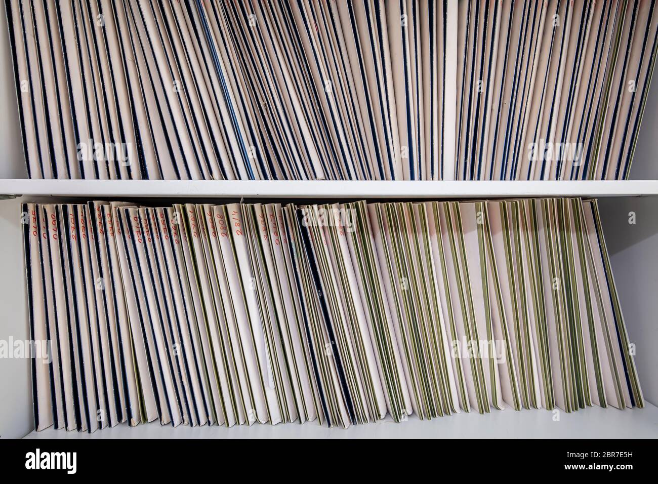 A shelf full of manila folders containing files and information in an ...