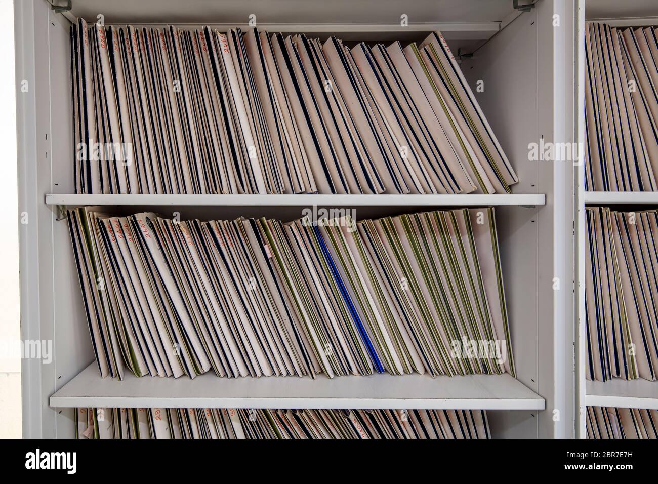 A shelf full of manila folders containing files and information in an ...