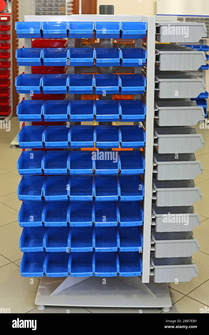 Storage Organizer Rack With Blue Plastic Sorting Bins Stock Photo - Alamy