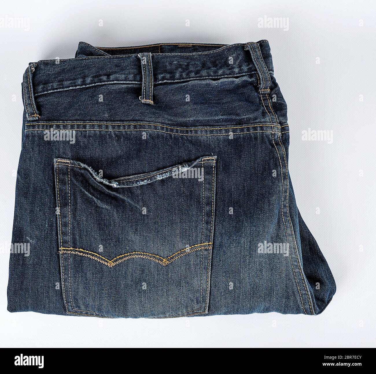 folded blue men's jeans on a white background, top view Stock Photo - Alamy