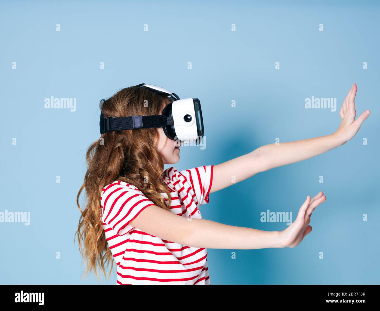 smiling positive girl wearing virtual reality glasses goggles headset ...