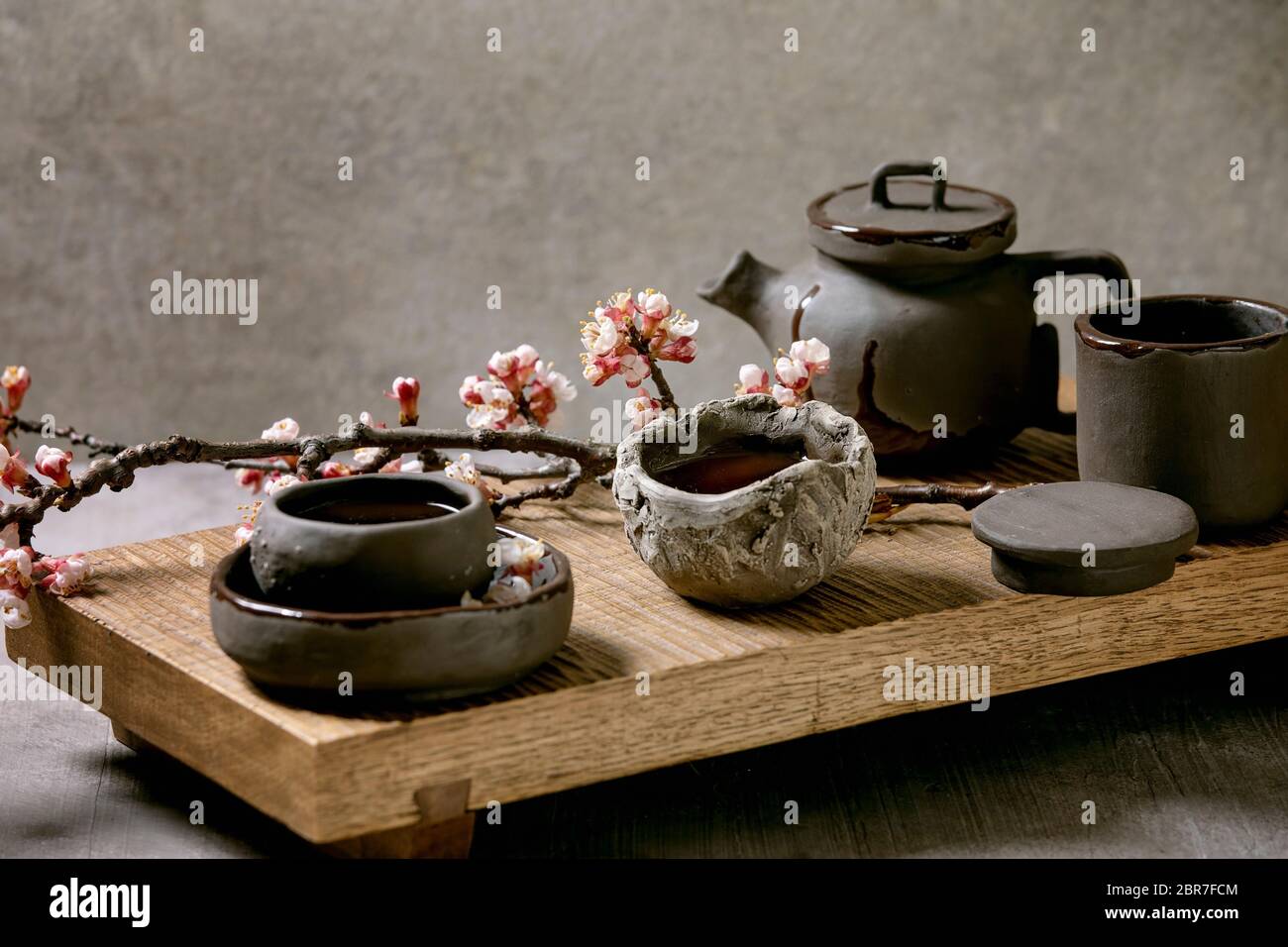 Tea drinking wabi sabi japanese style dark clay cups and teapot on ...