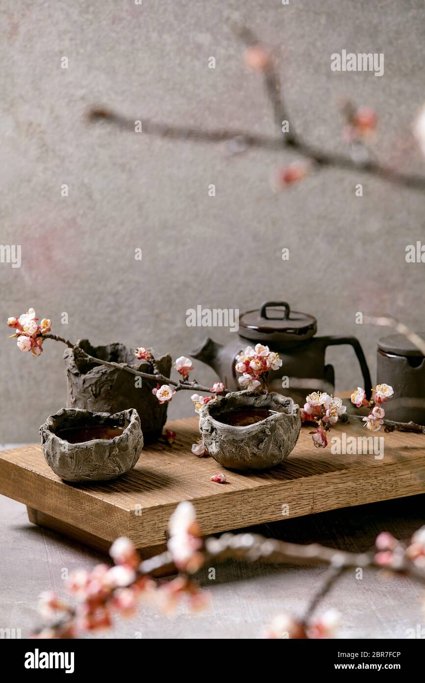 Tea drinking wabi sabi japanese style dark clay cups and teapot on ...