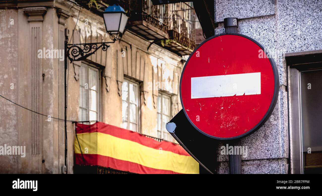 forbidden sign round on a street with the typical architecture of Spain ...